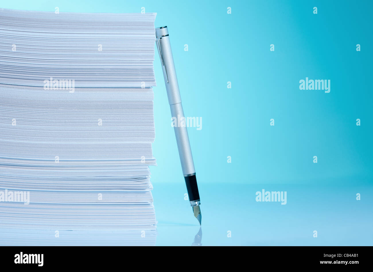 Fountain pen and paper on light blue background Stock Photo - Alamy
