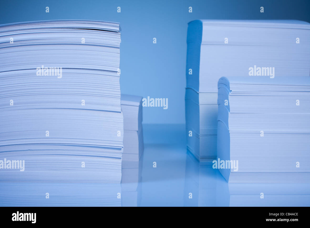 Many paper piles on blue background Stock Photo - Alamy