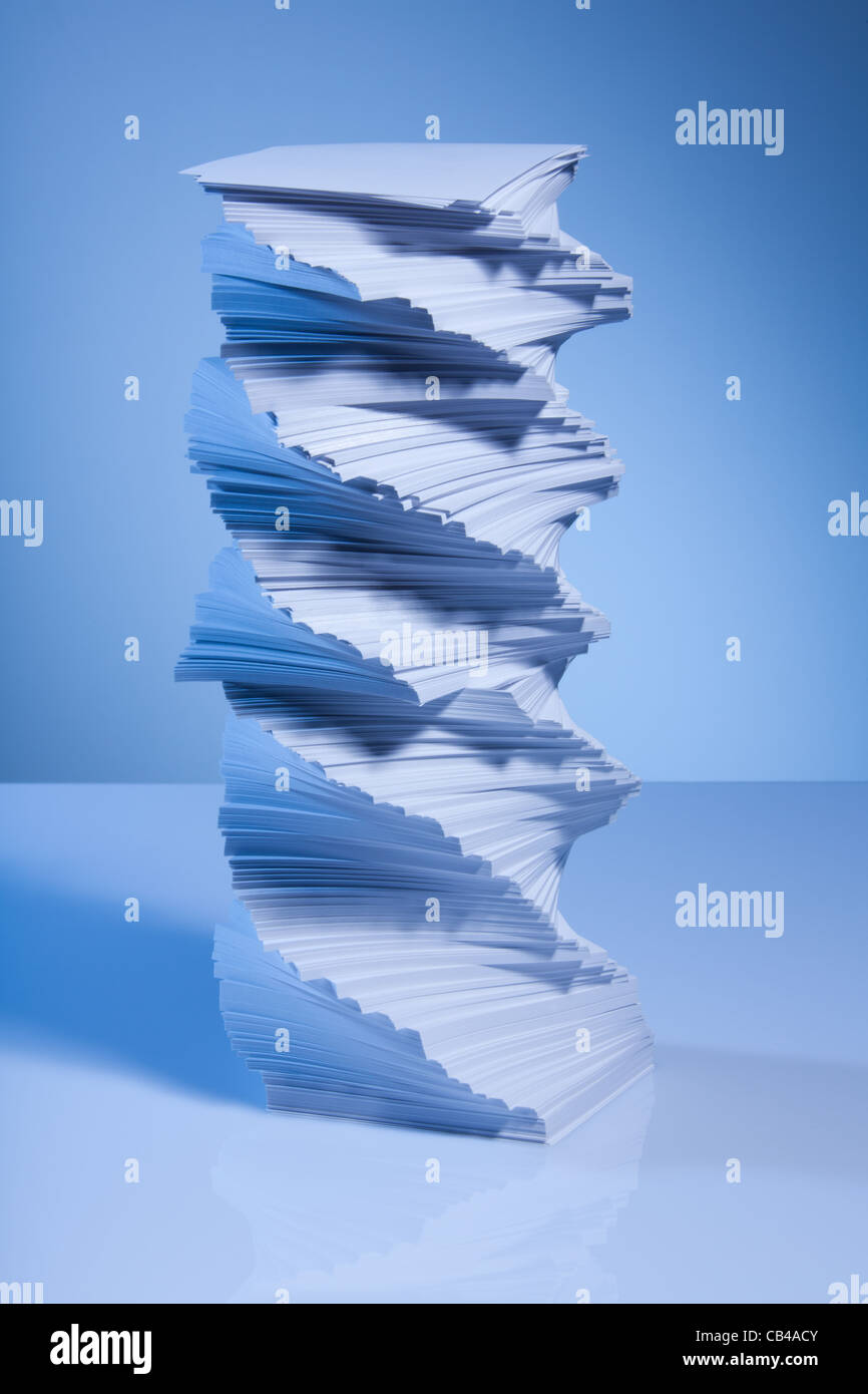 Big pile of paper on blue background Stock Photo - Alamy