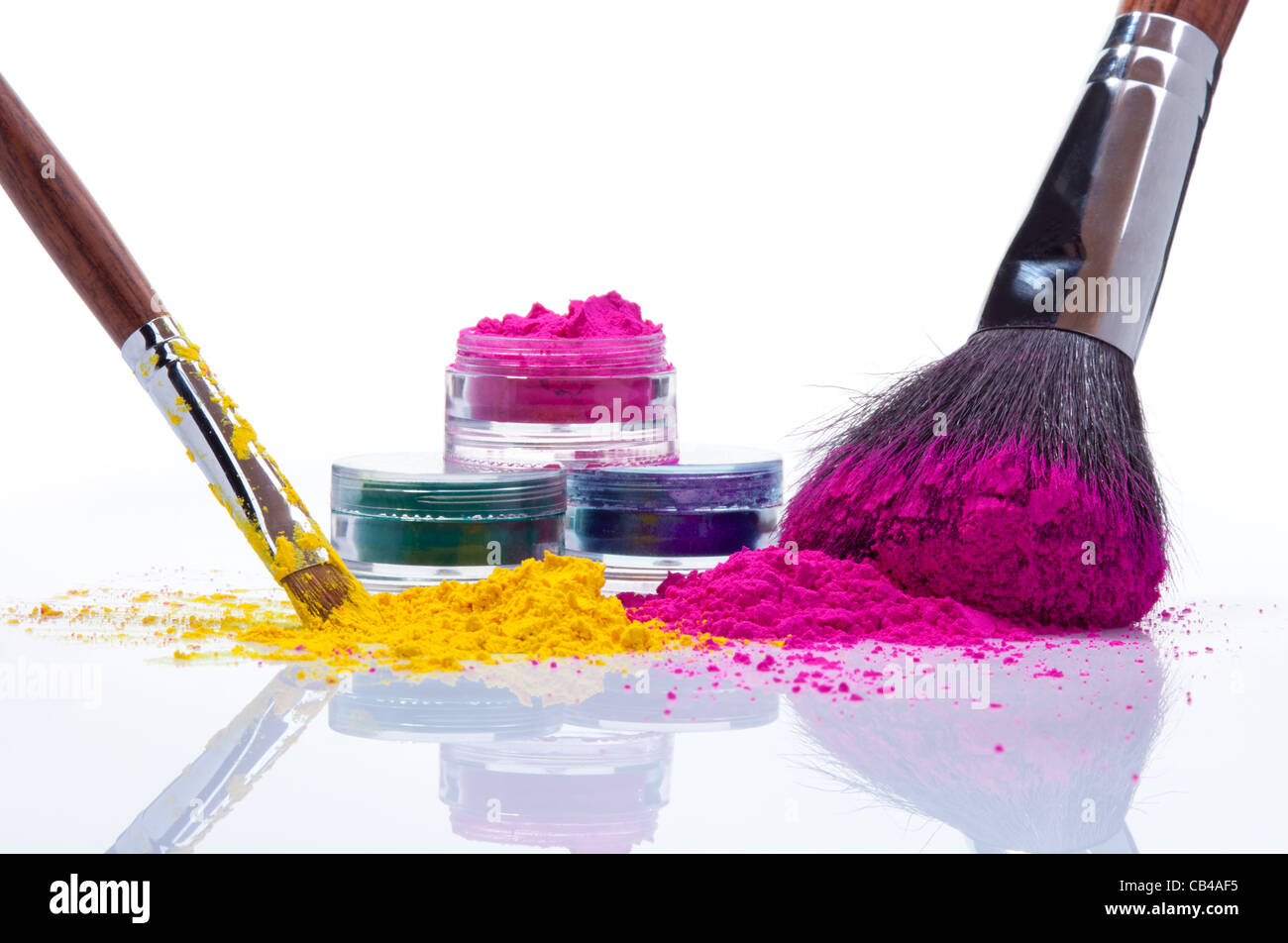 Makeup powder of different colors and brushes Stock Photo - Alamy