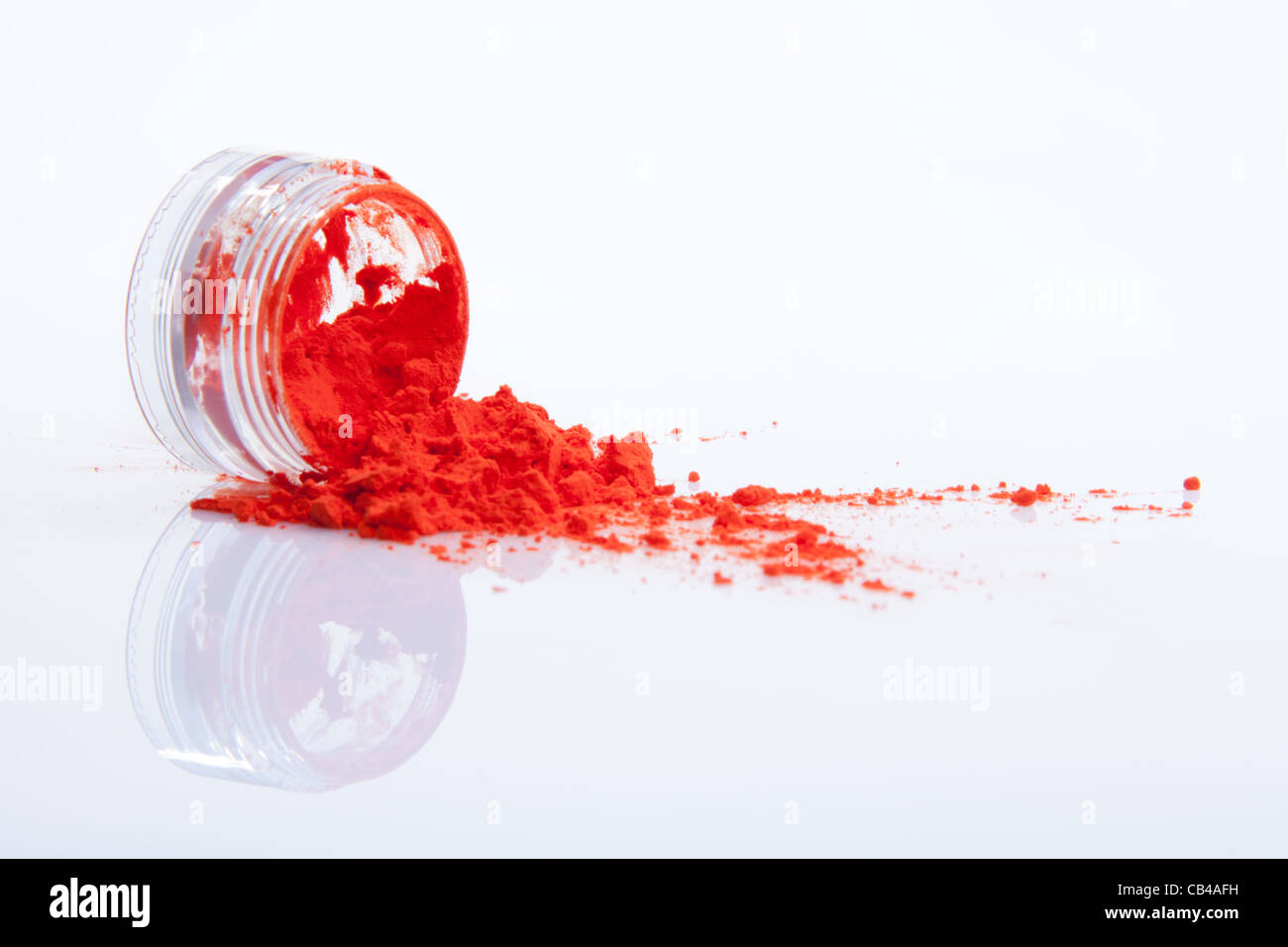 spilled red makeup powder from jar Stock Photo - Alamy