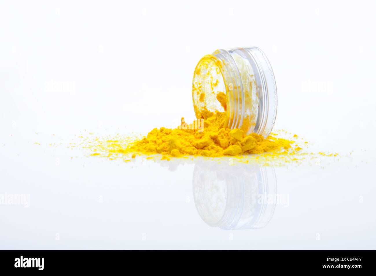 spilled yellow makeup powder from jar Stock Photo - Alamy