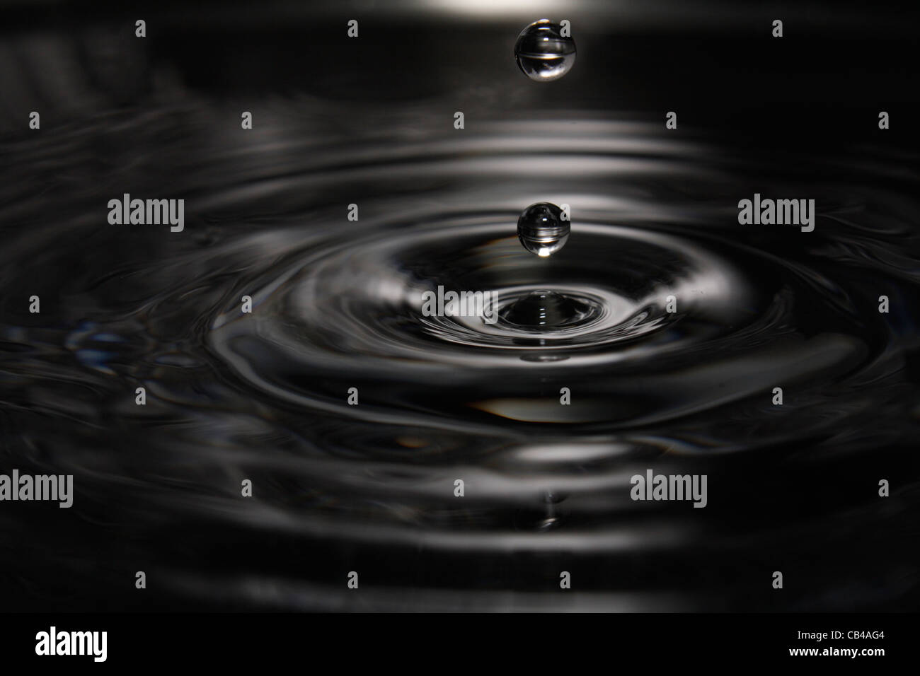 Water droplets caused by single drop of water Stock Photo - Alamy