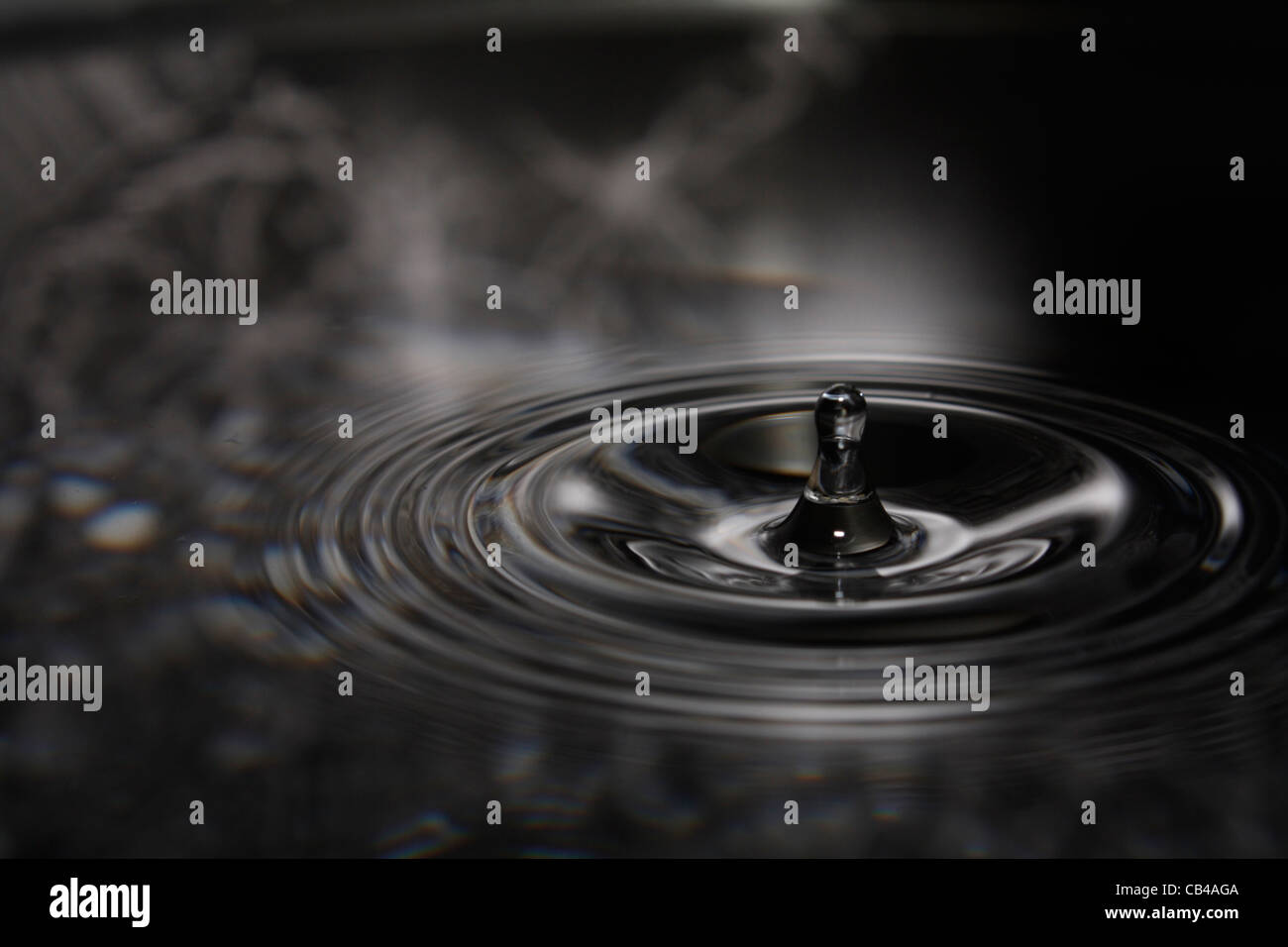 Water emerging from single drop Stock Photo - Alamy