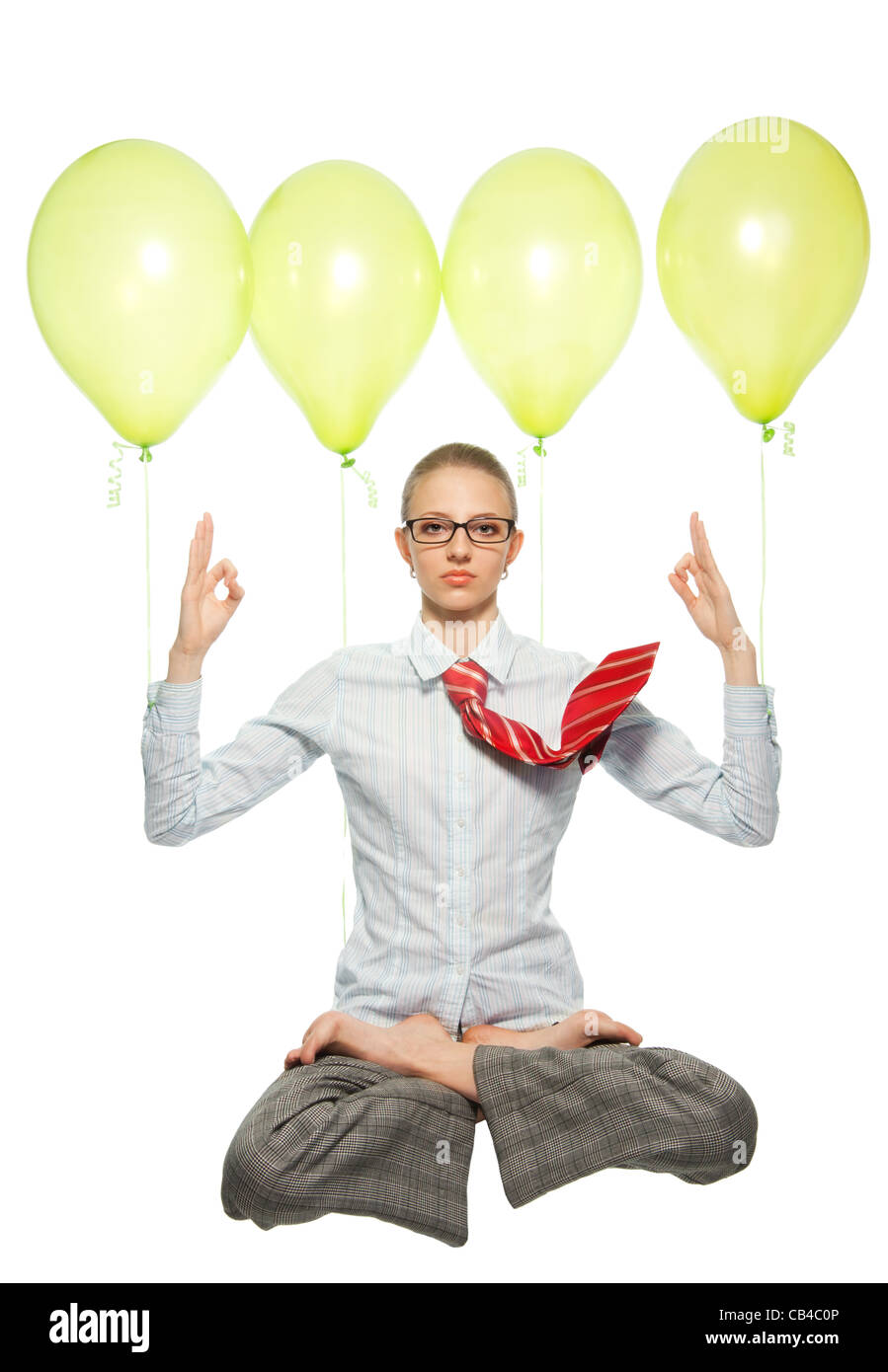 business woman sitting in lotus yoga pose and flying on air balloons ...
