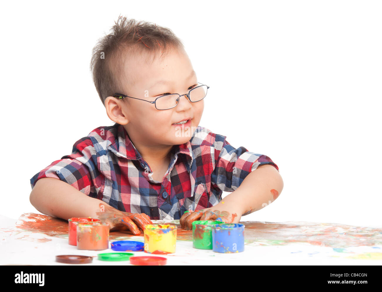 Little Chinese boy drawing with hands paint and warring glases Stock ...