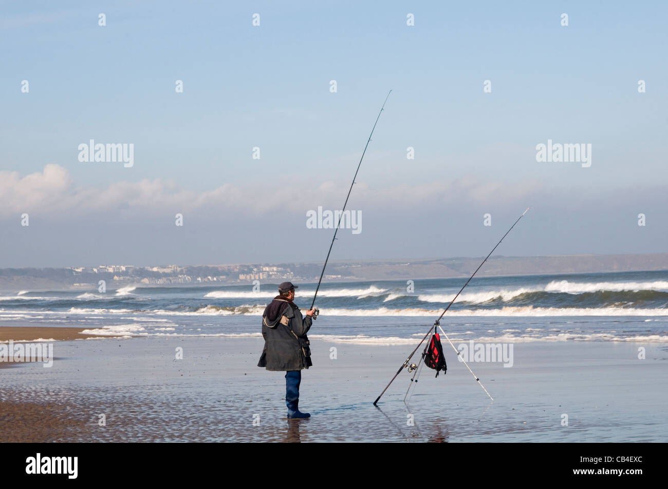 man fishing from the beach at hunmanby gap east yorkshire coast beach ...