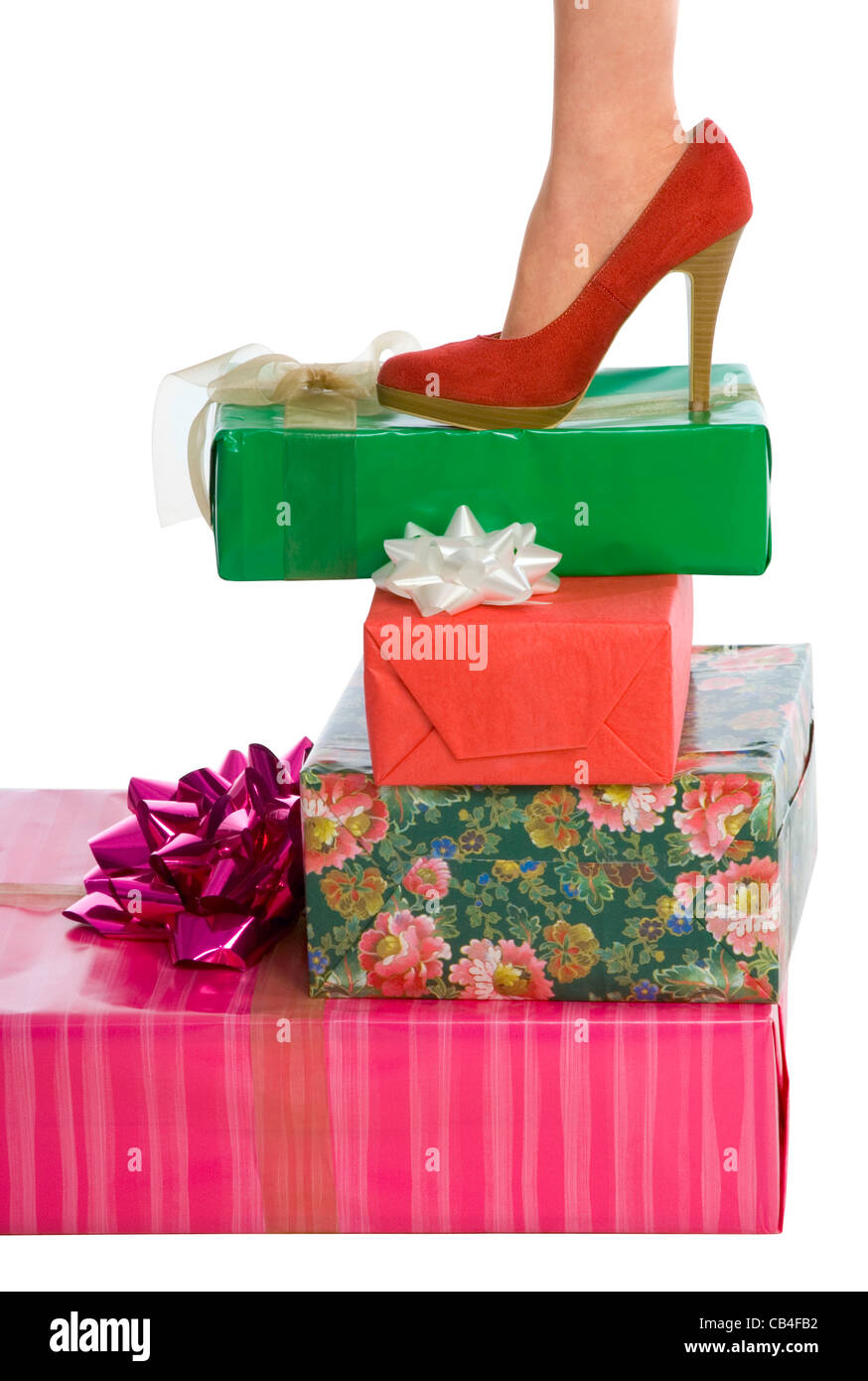 Female Leg in red shoe standing on stack of wrapped gifts Stock Photo ...
