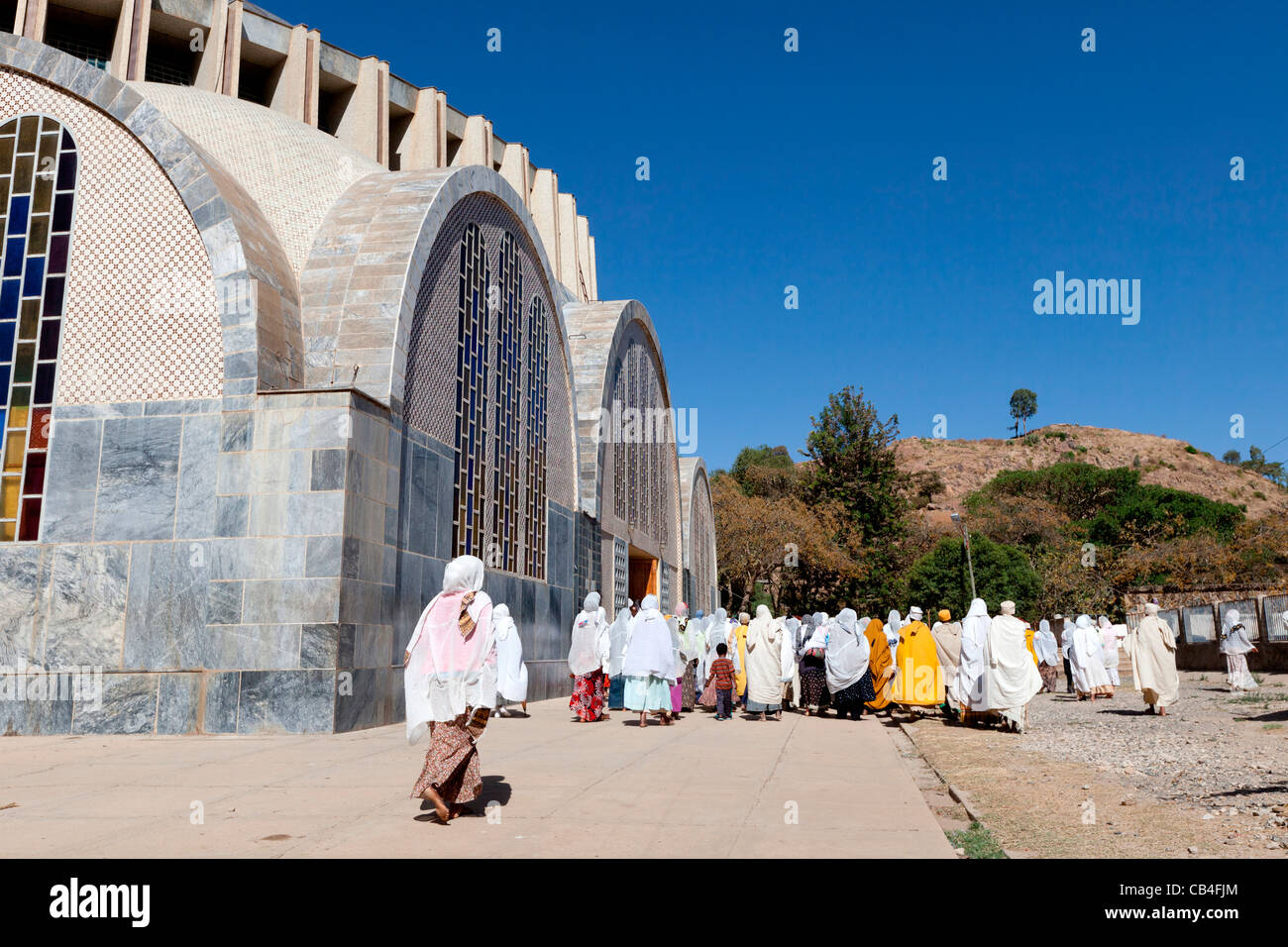 A procession of Orthodox Christian devotees walk around the new church ...