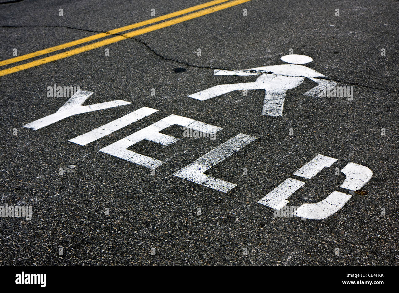 Warning at crossroad saying yield and person sign on asphalt Stock ...