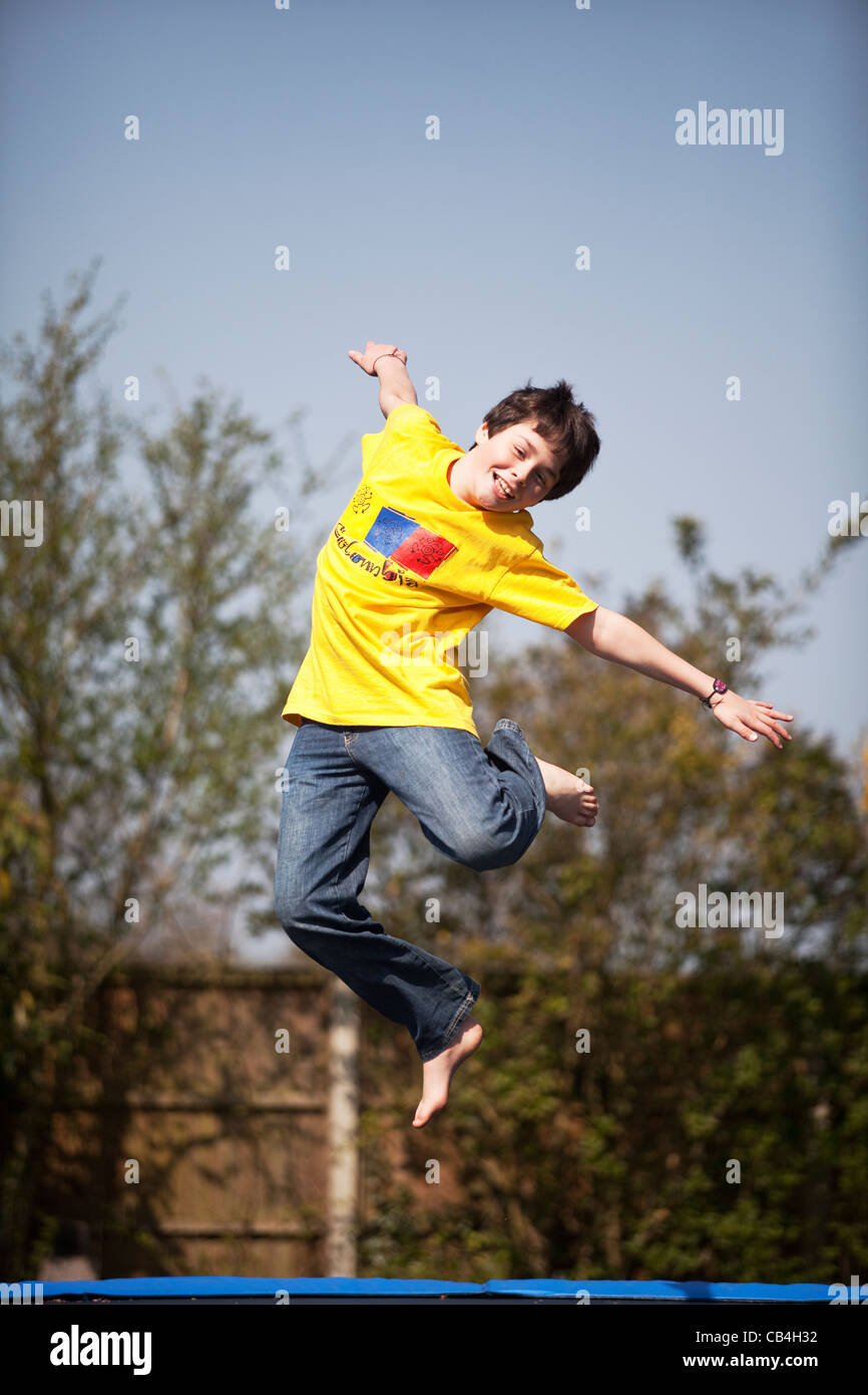Leaping boy on trampoline Stock Photo - Alamy
