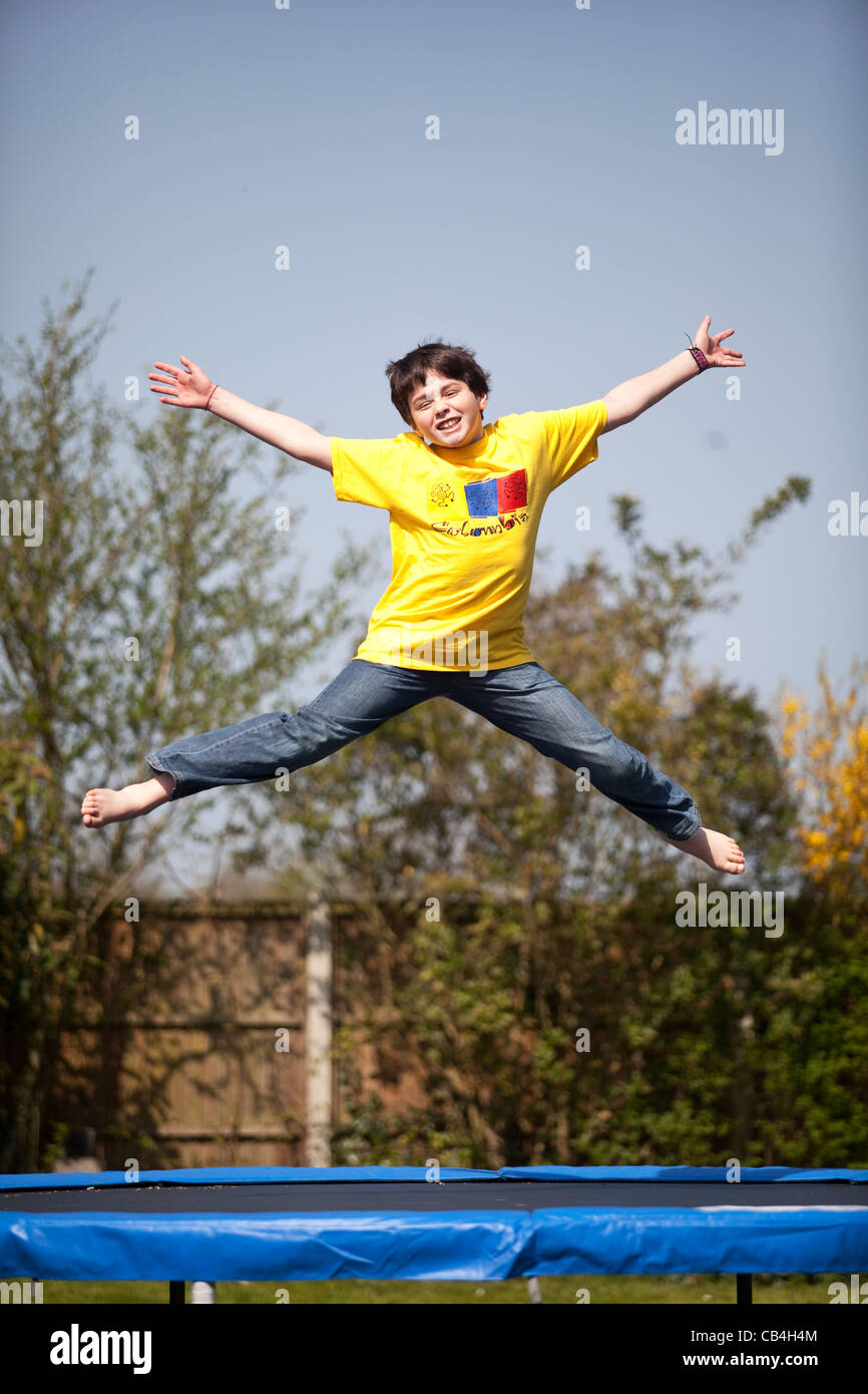 Leaping boy on trampoline Stock Photo - Alamy