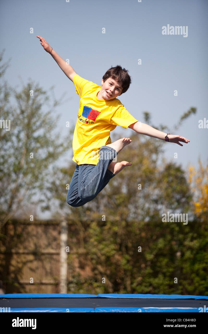 Leaping boy on trampoline Stock Photo - Alamy