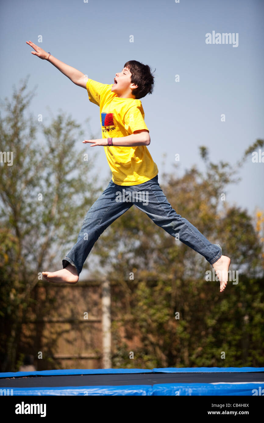 Leaping boy on trampoline Stock Photo - Alamy