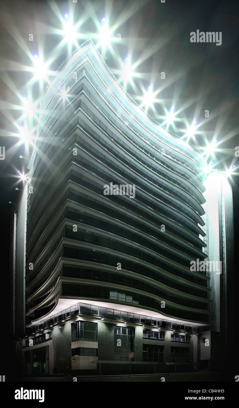 Night view of the modern high-rise building illuminated with lamps from ...