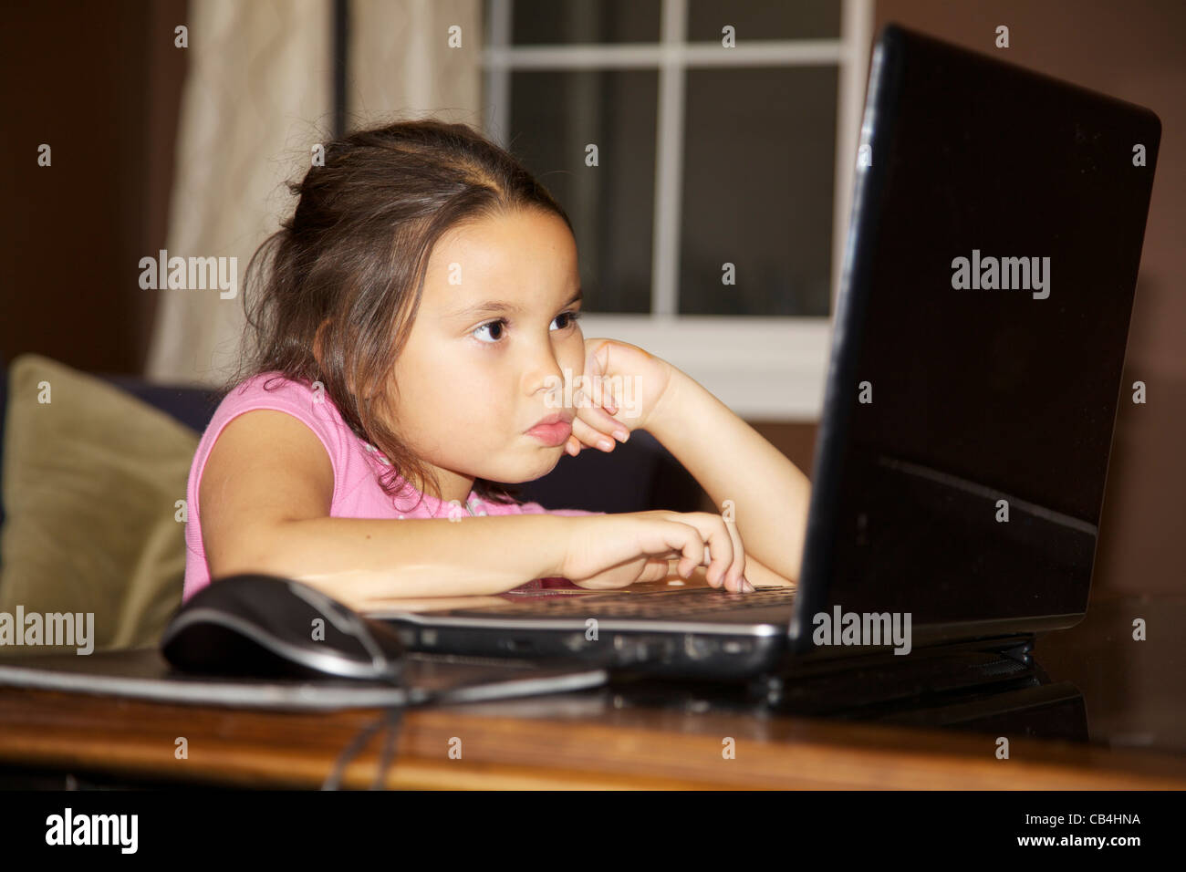 Seven year old girl using laptop computer Stock Photo - Alamy