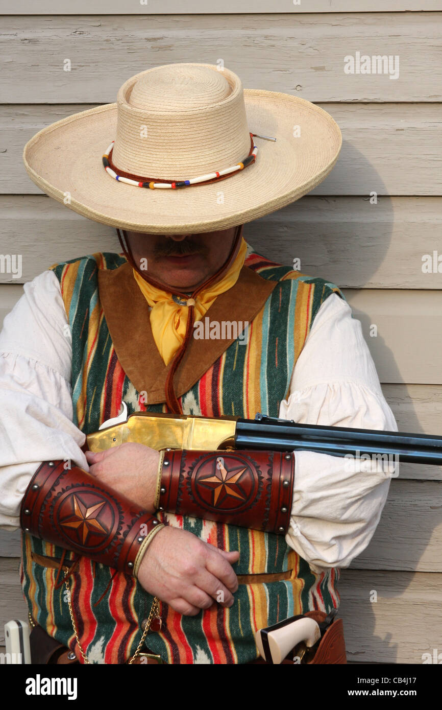 A cowboy leaning against a building Stock Photo - Alamy