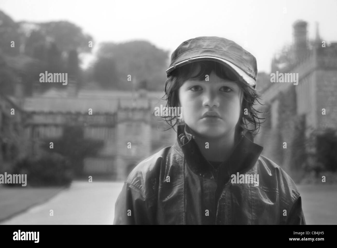 A soaking wet boy with hat on Stock Photo - Alamy