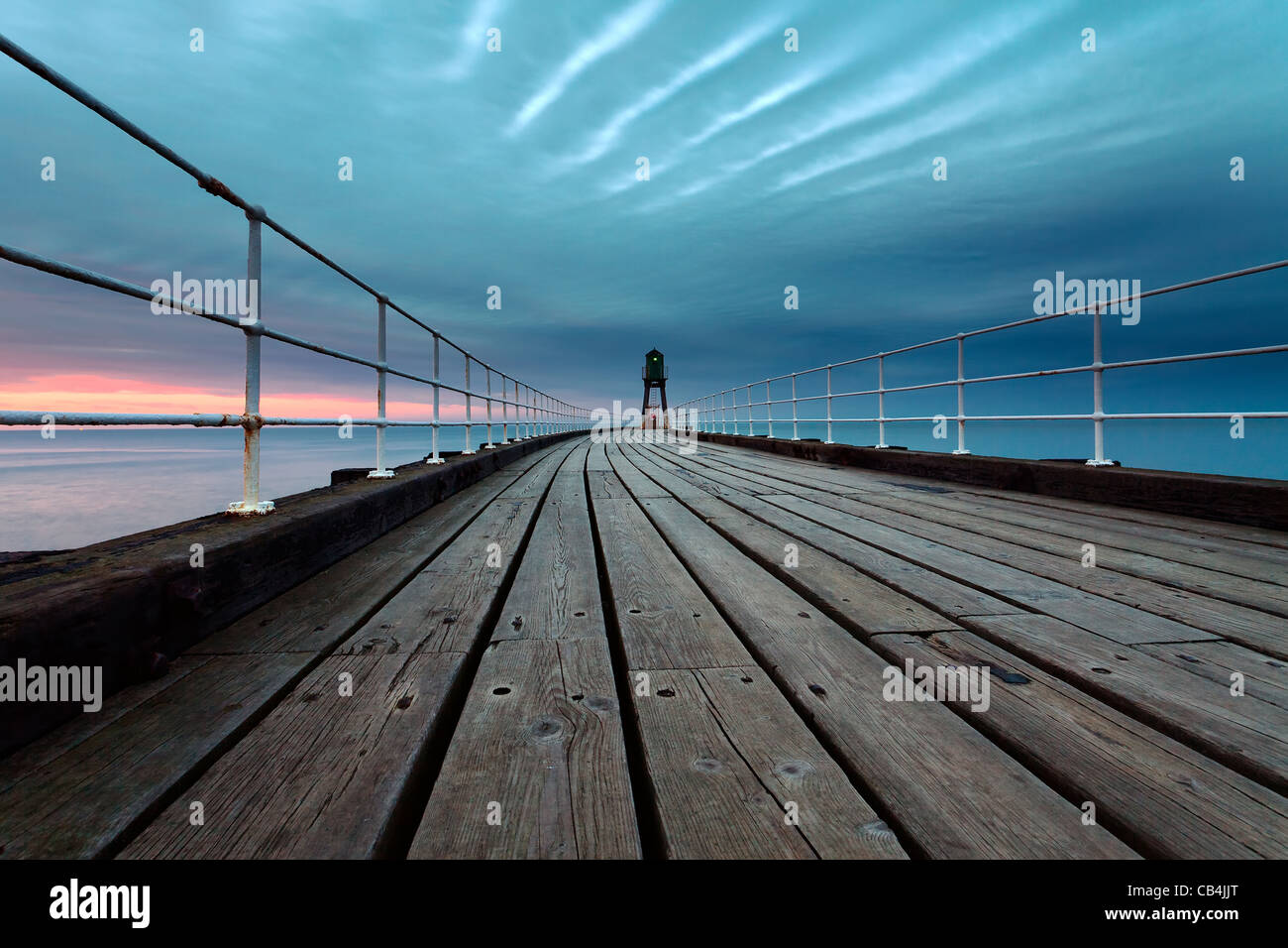 A graphical shot of Whitby pier looking towards the lighthouse Stock ...