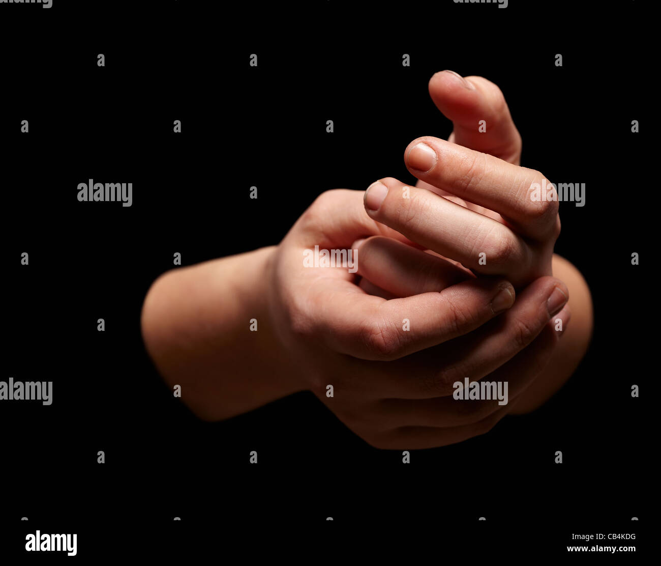 Hands holding one another isolated on black background Stock Photo - Alamy