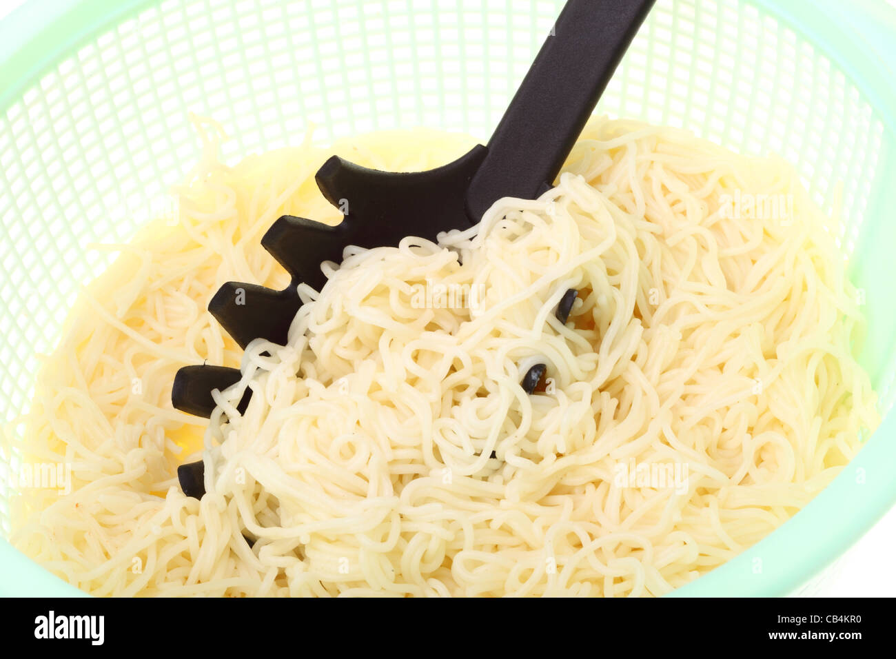 noodles in green colander isolated on a white background Stock Photo ...