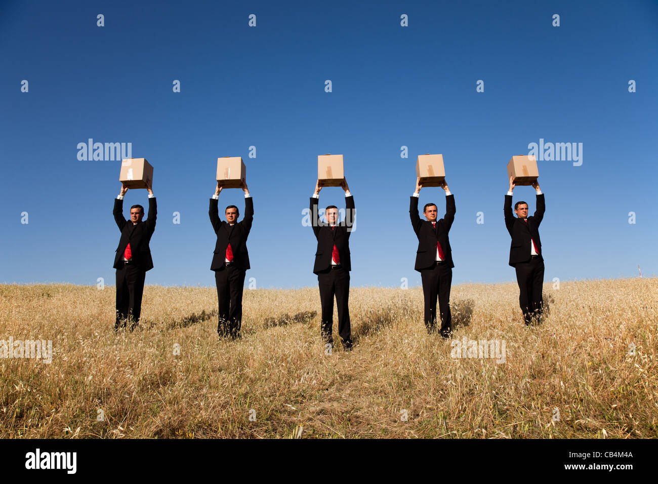 five businessman lineup holding a cardboard box over his head Stock ...