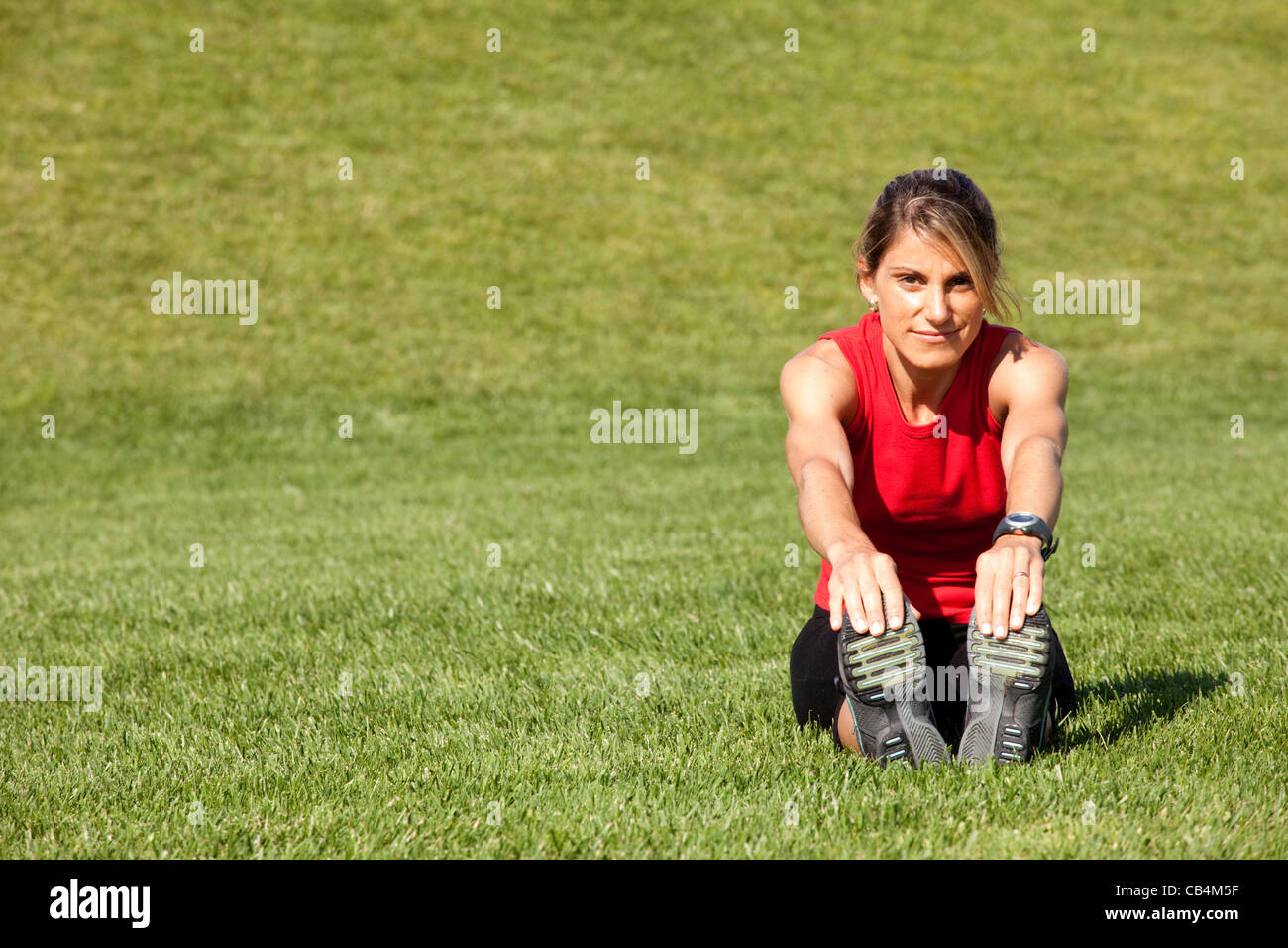 young woman doing some exercise at the park Stock Photo - Alamy