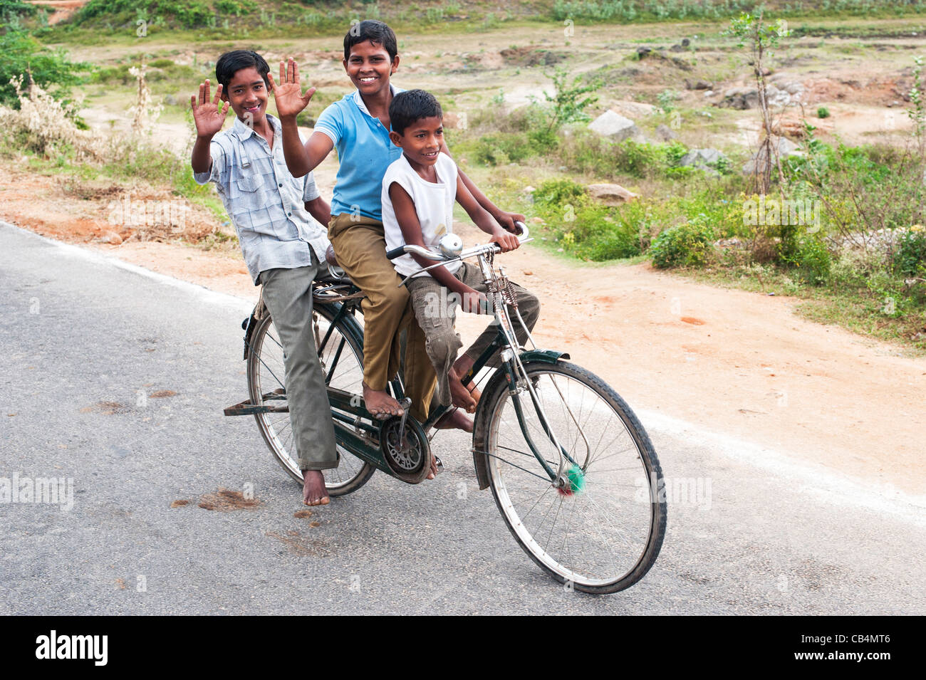 Three Indian children riding a bicycle. Andhra Pradesh, India Stock ...