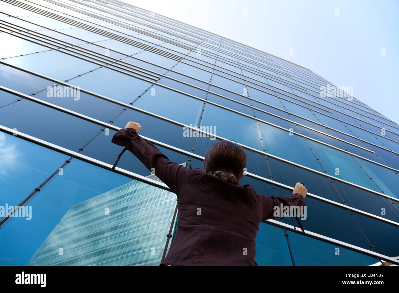 successful businesswoman looking up next to her office building Stock ...