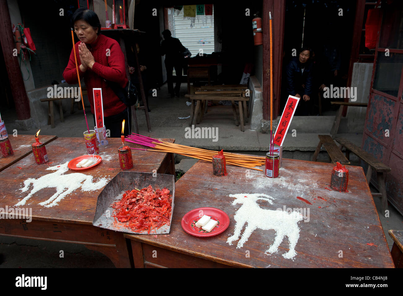 A Chinese lady pray during Xiayuan Festival at a Taoist temple in ...