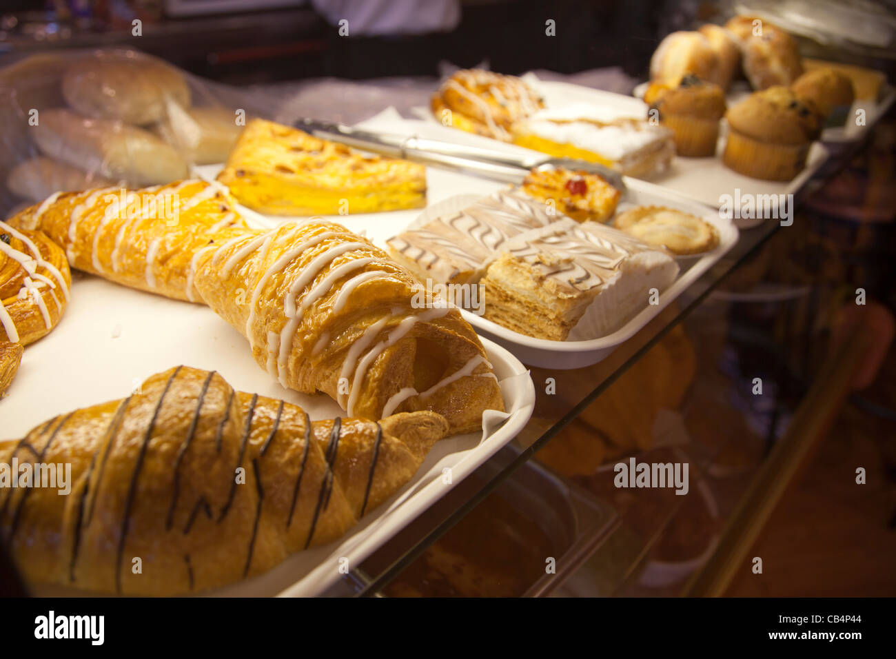 Pastries behind glass counter Stock Photo - Alamy