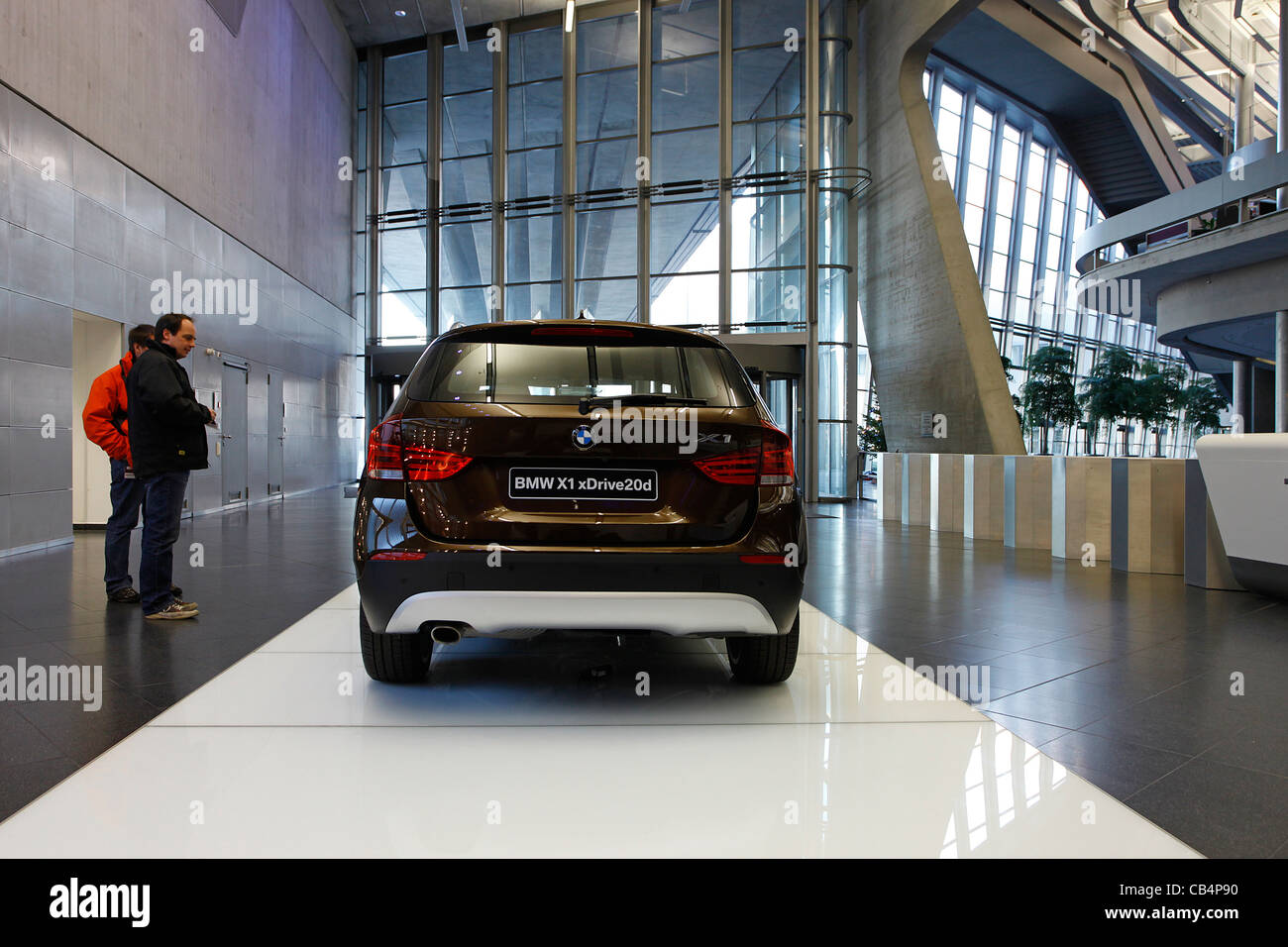 Men inspecting new BMW car model at the reception hall of BMW ...