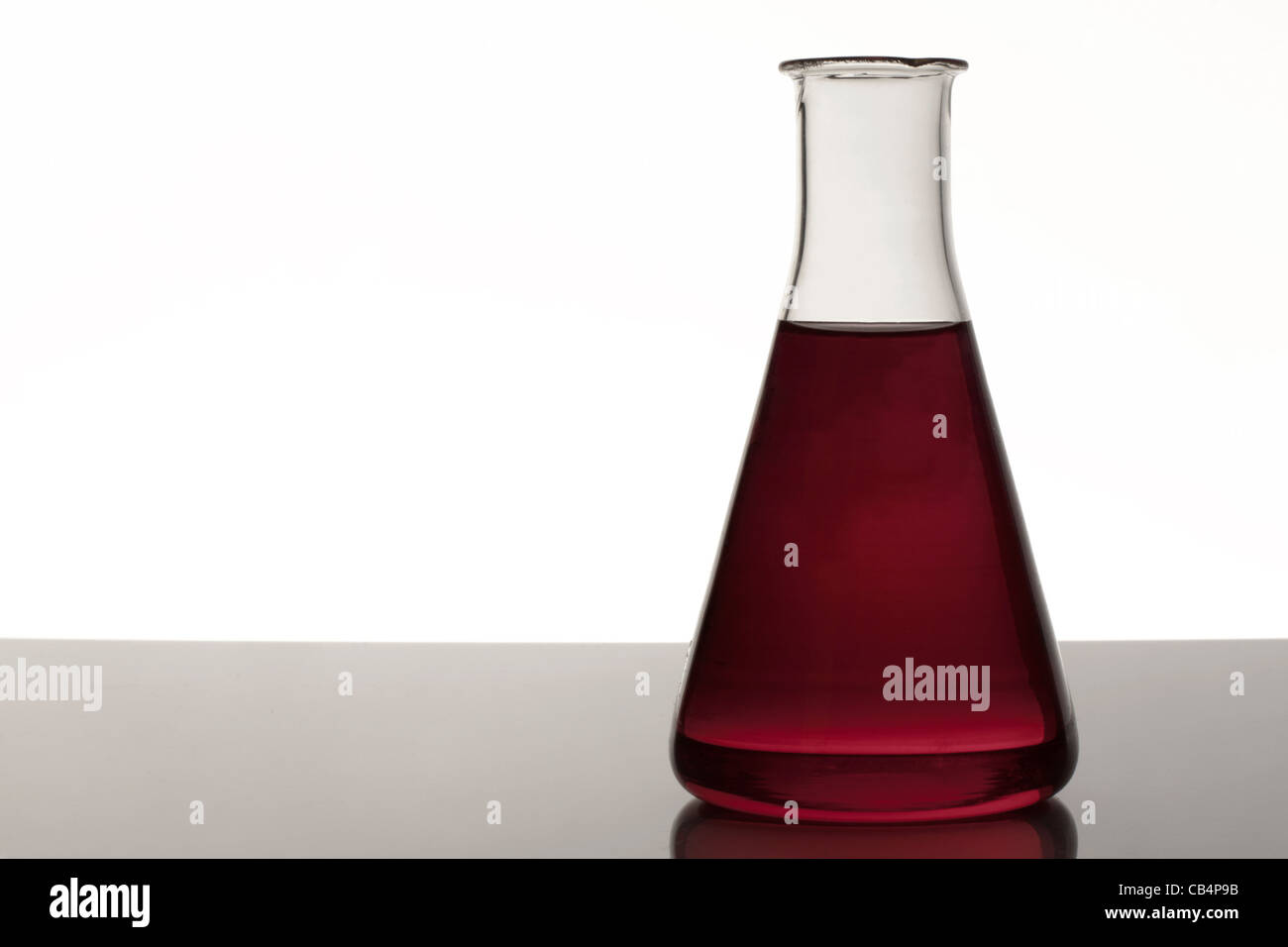 close up detail of laboratory beakers with different coloured liquid in ...