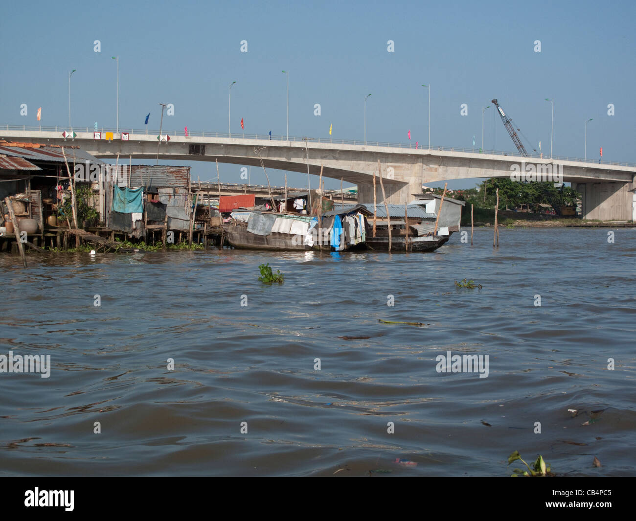 View of stilt houses and boats and Can Tho Bridge in the Mekong Delta ...