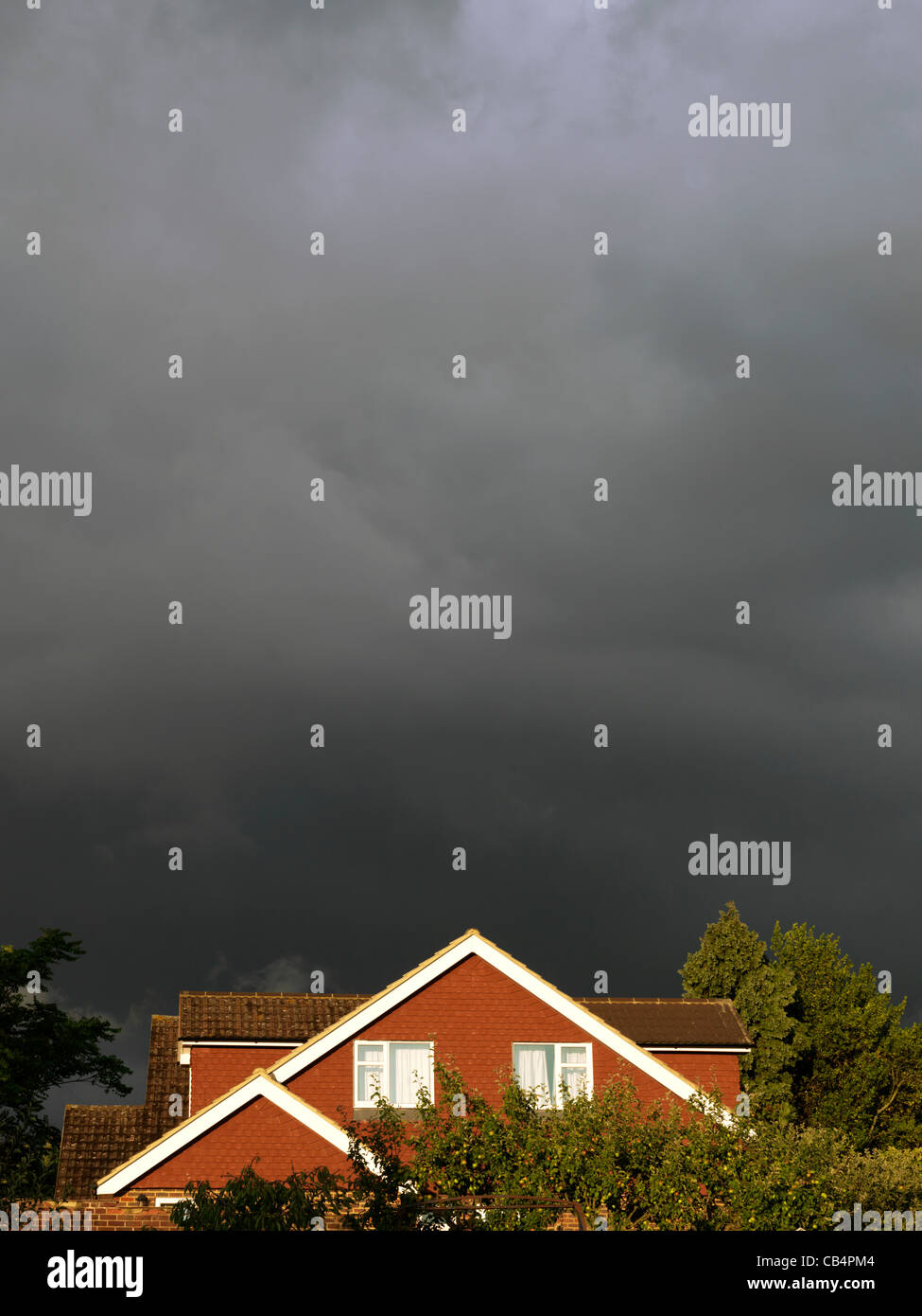 Storm Clouds Over House England Stock Photo - Alamy