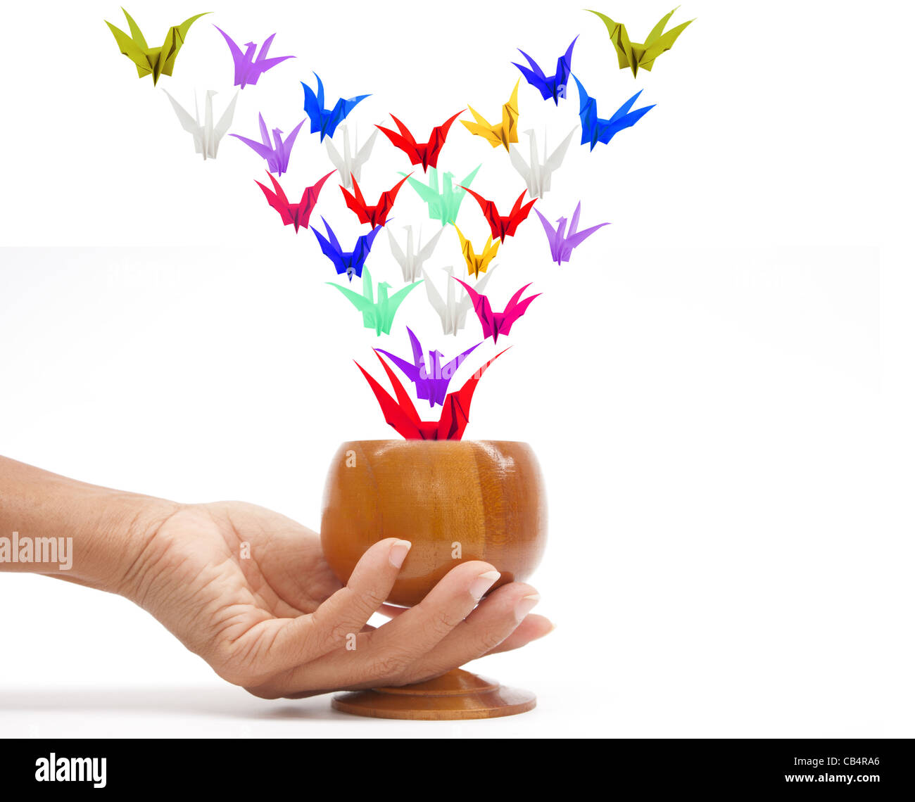 Paper birds flying from magic cup Stock Photo - Alamy