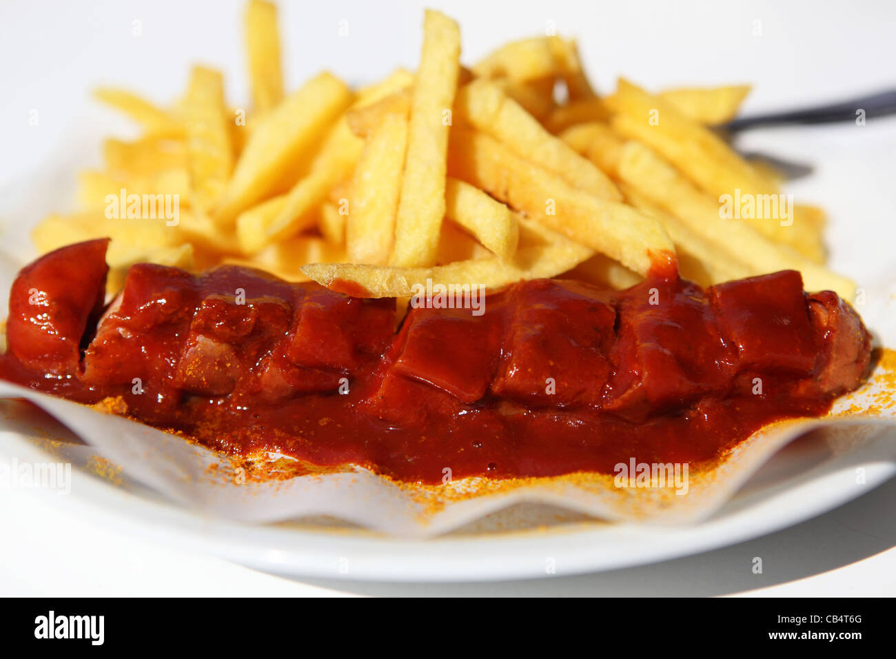Currywurst and Pommes (Curried sausage and chips) is served at a fast ...