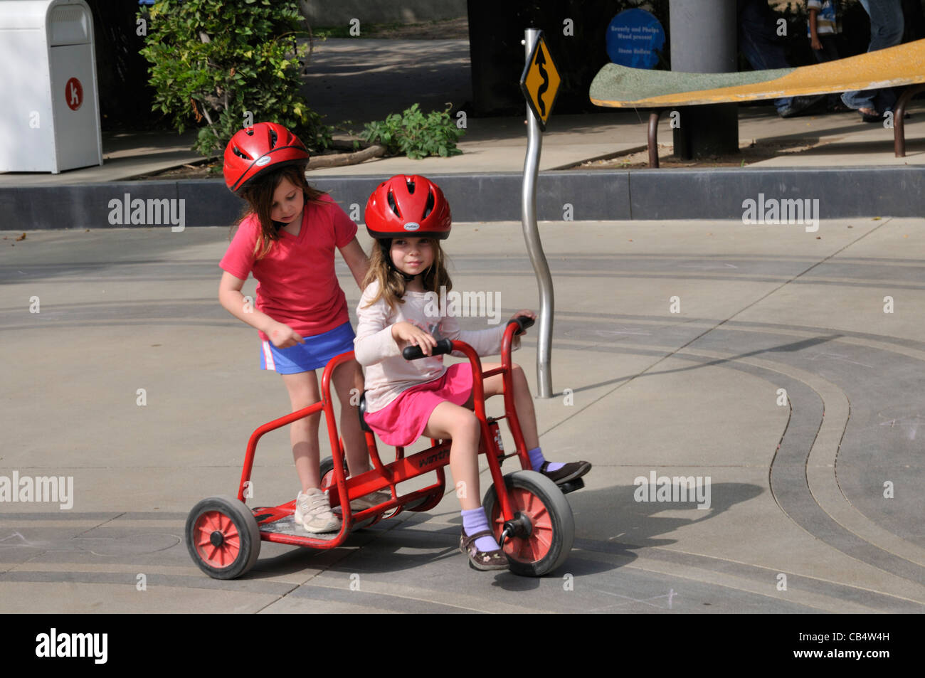 Children having fun sharing a bike at Kidspace Children's Museum ...