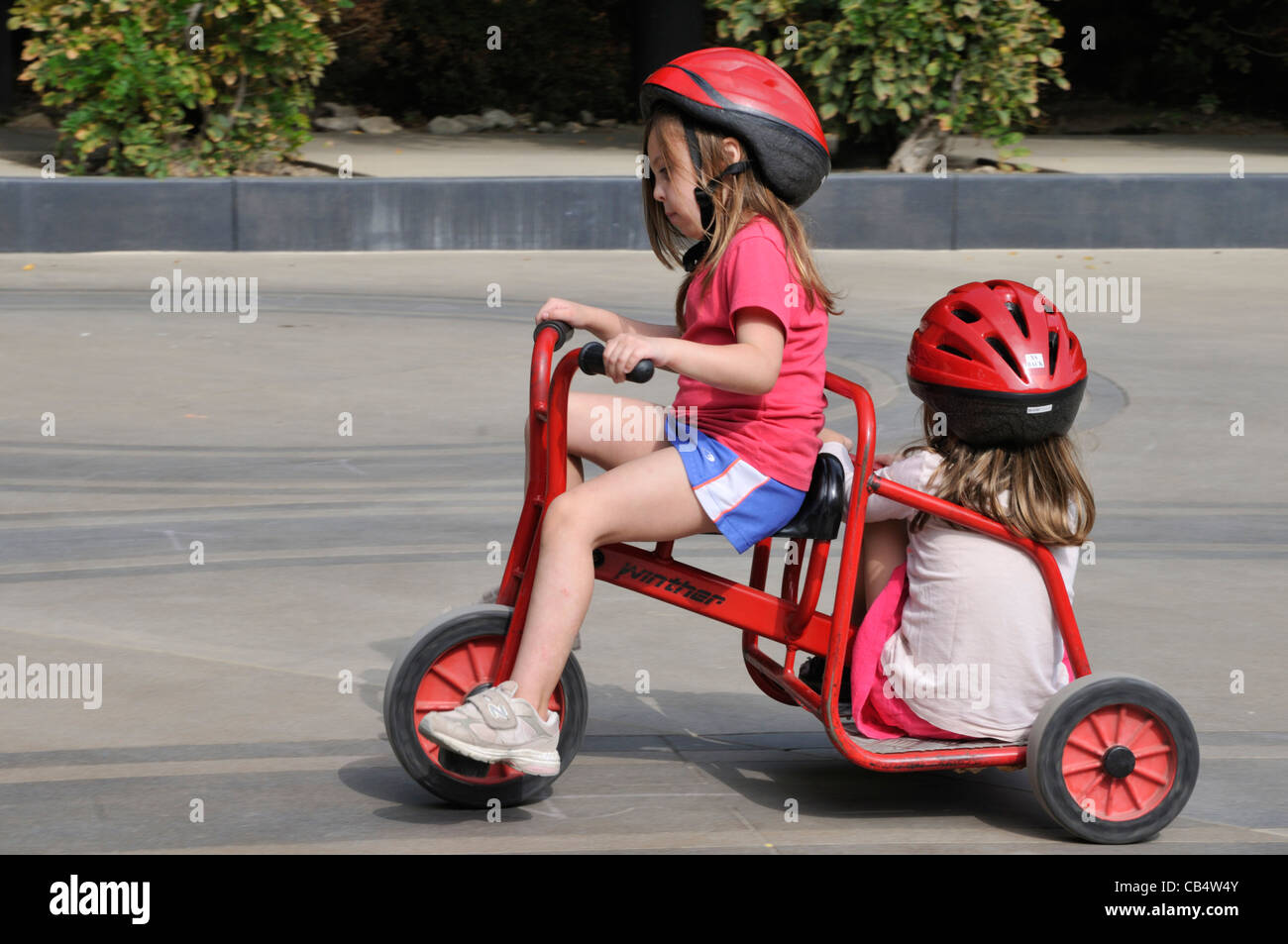 Children having fun sharing a bike at Kidspace Children's Museum ...