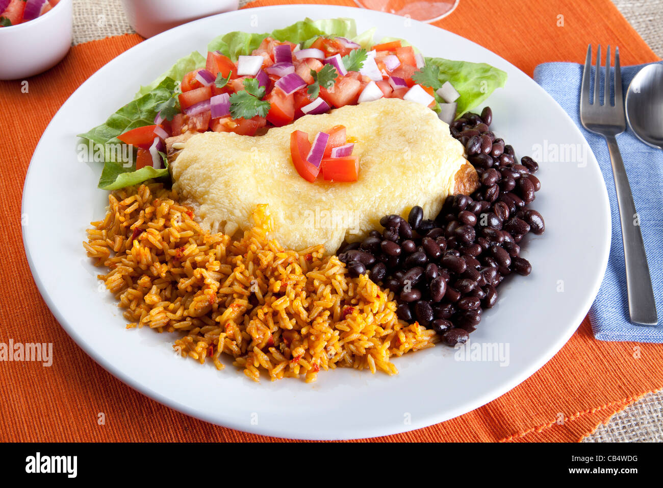 Burrito plate with a side of black beans rice and a fresh salad Stock ...