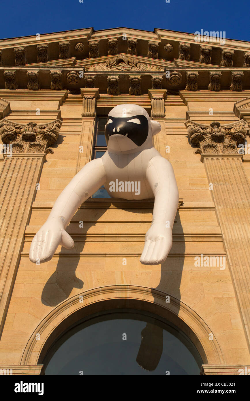 Inflatable sculpture on facade of the Louvre museum as part of the ...