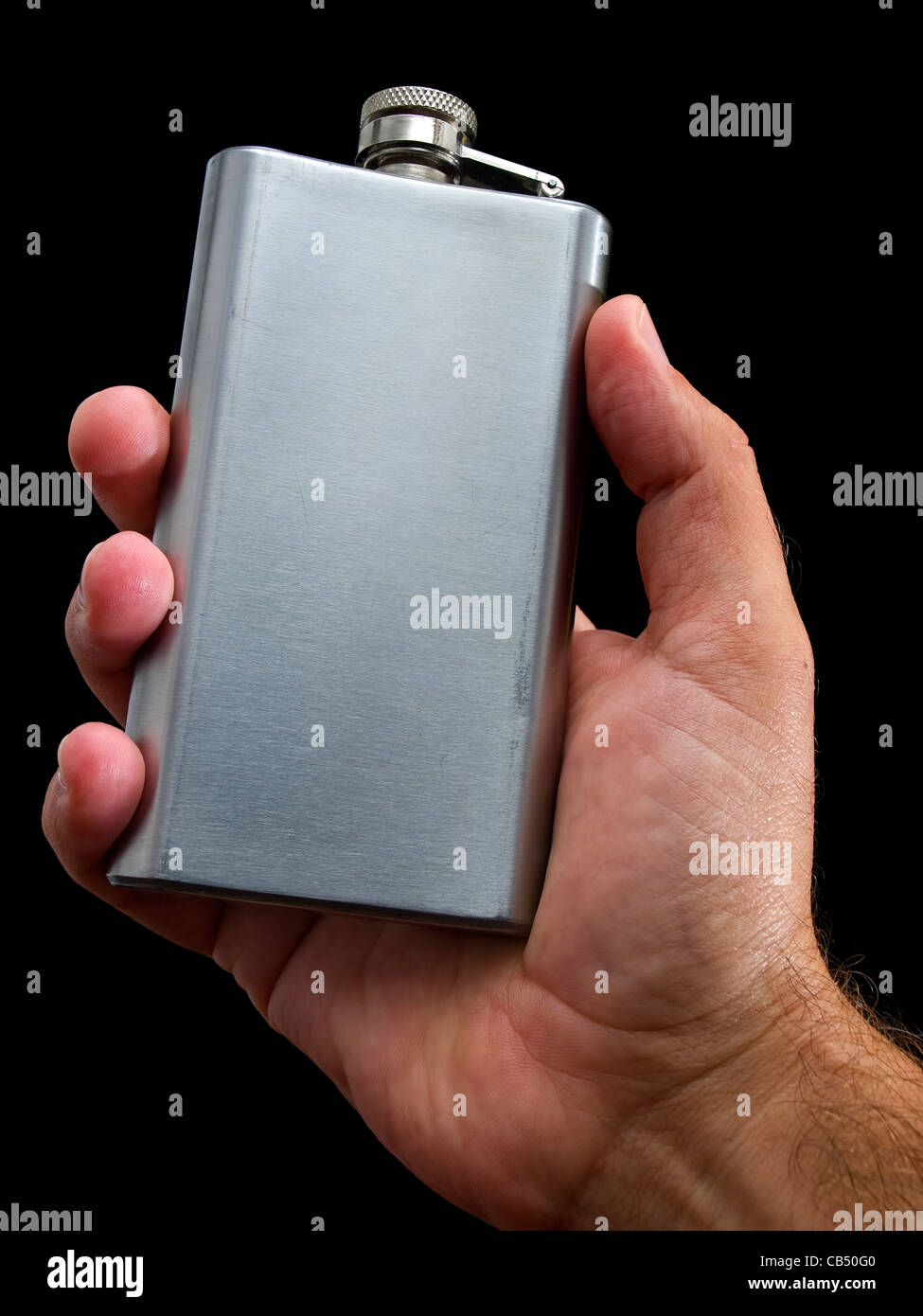 Hip flask in man's hand on a black background Stock Photo - Alamy