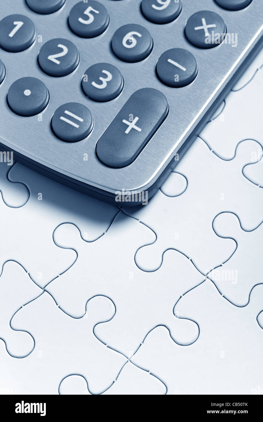 calculator and Puzzle, business concept of Solution Stock Photo - Alamy
