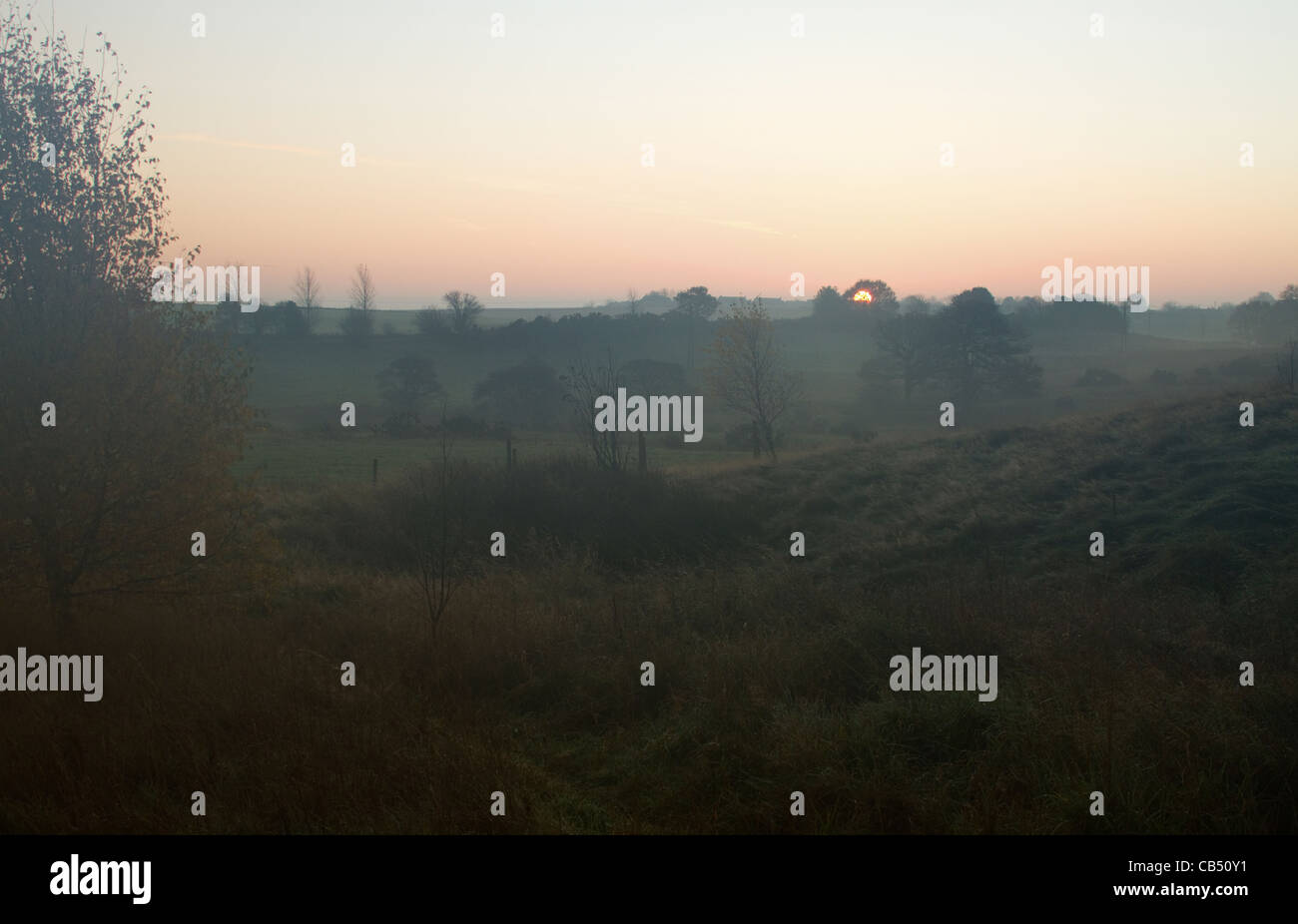 Sunrise over farmland Stock Photo - Alamy