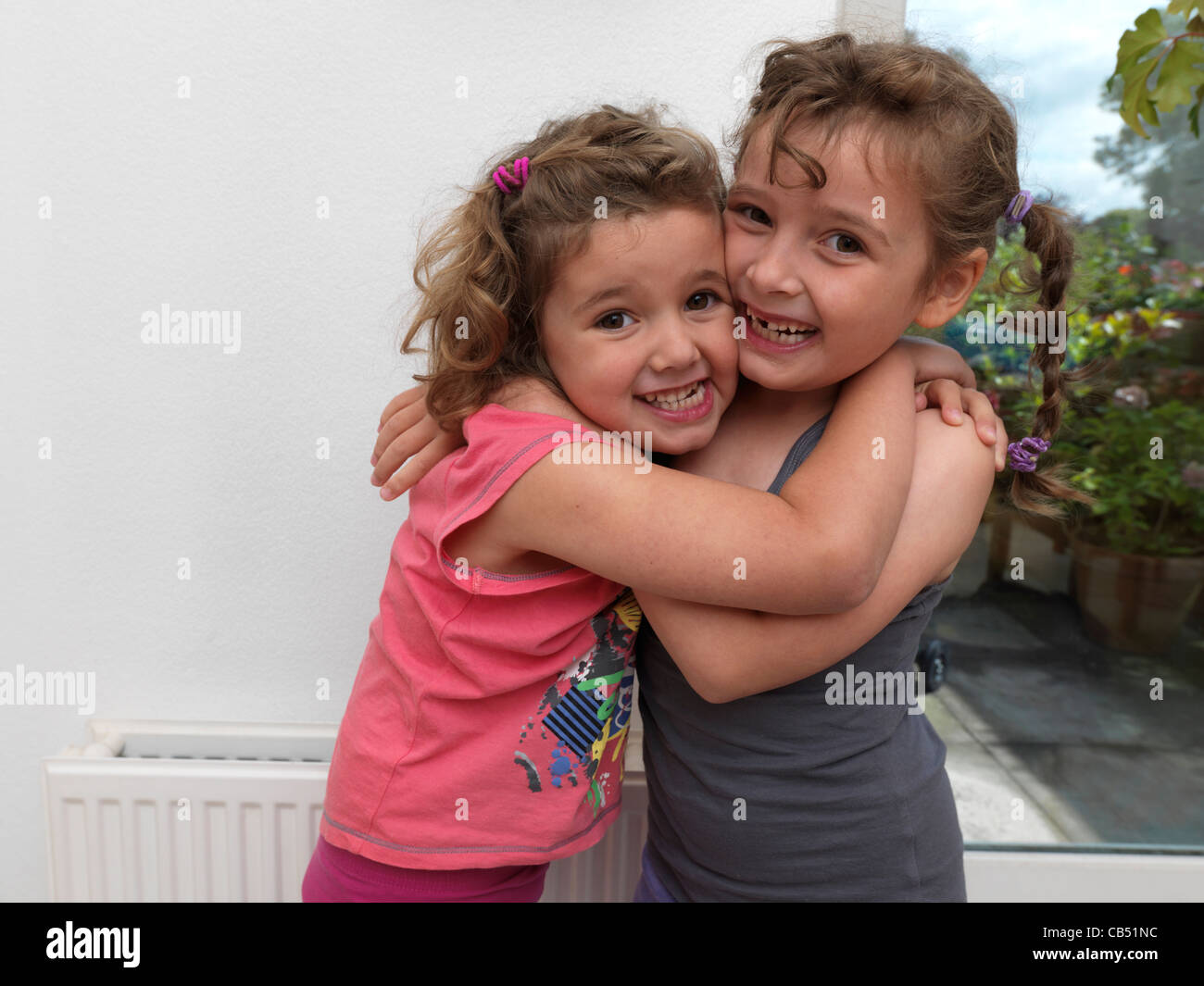 Sisters Hugging Each Other Stock Photo - Alamy