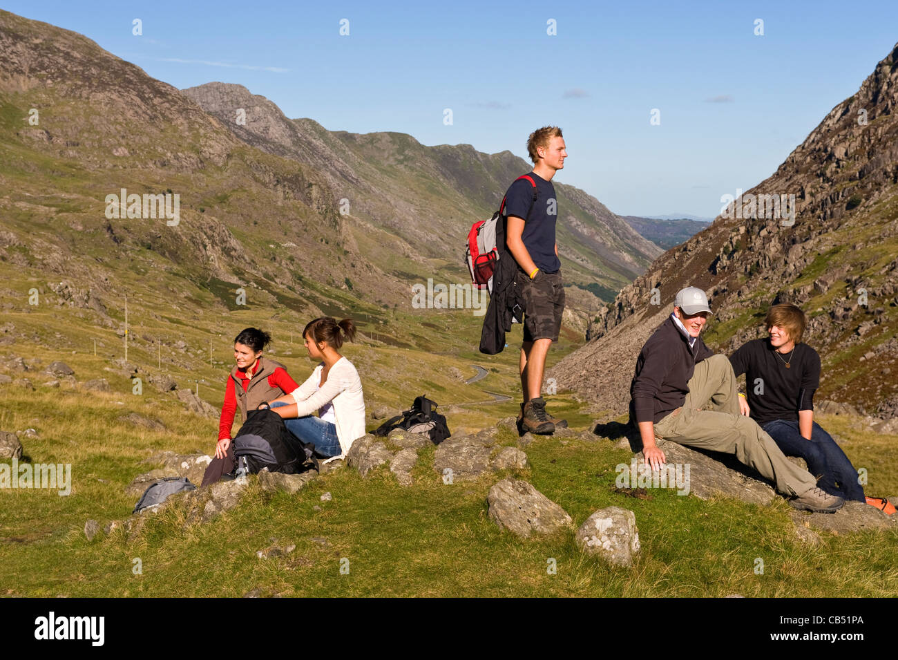 A group of young males and females hiking in Snowdonia National Park ...