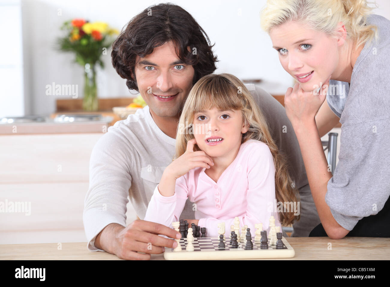 Family playing chess Stock Photo - Alamy
