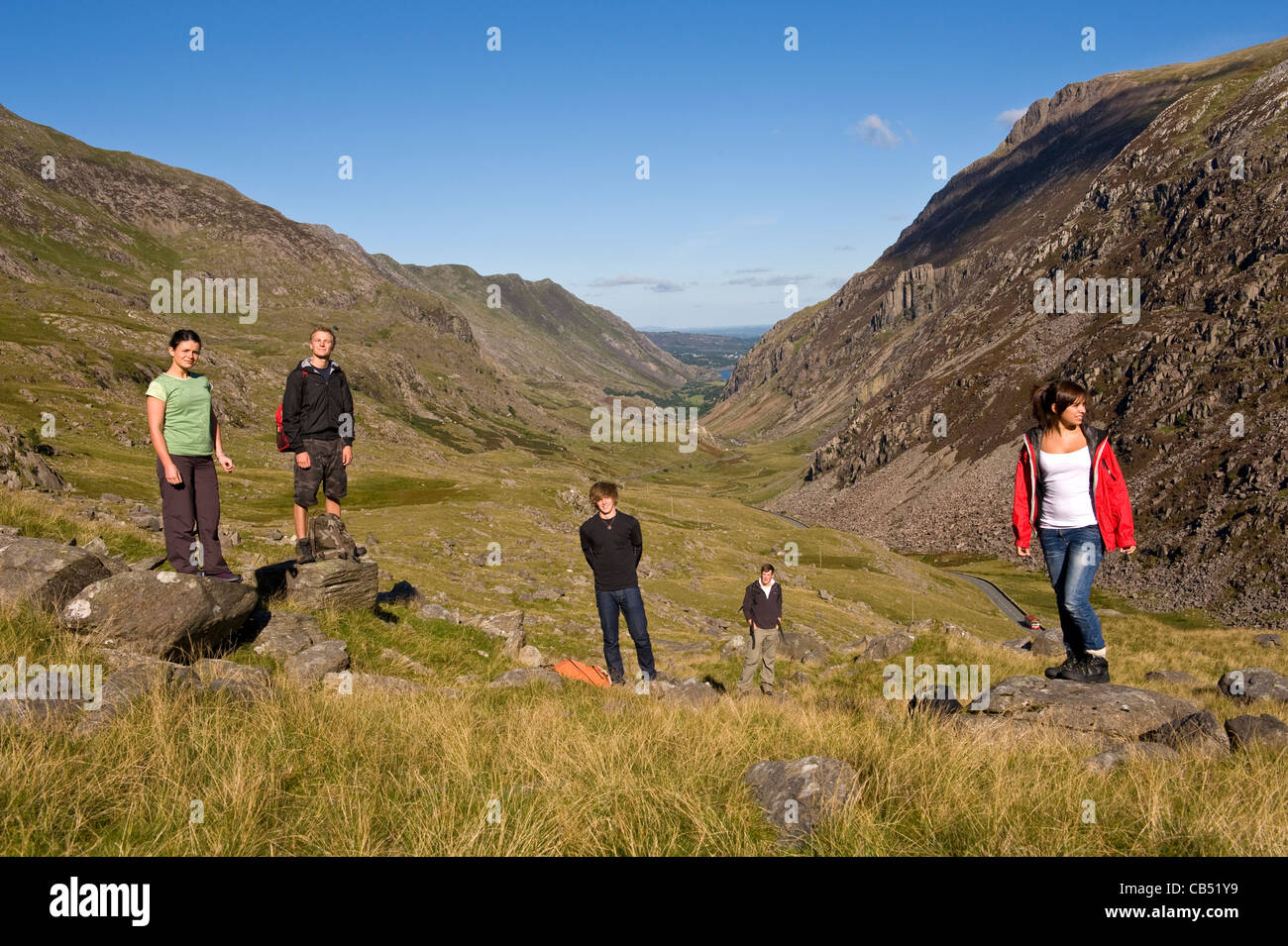 A group of young males and females hiking in Snowdonia National Park ...