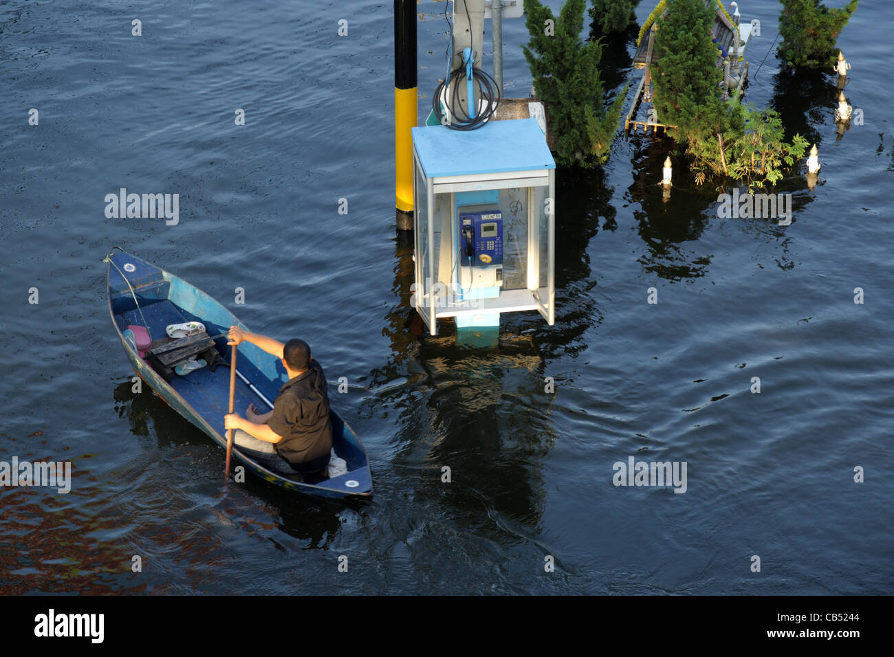 A man padding in floodwaters on street at Pakkred , Nonthaburi province ...