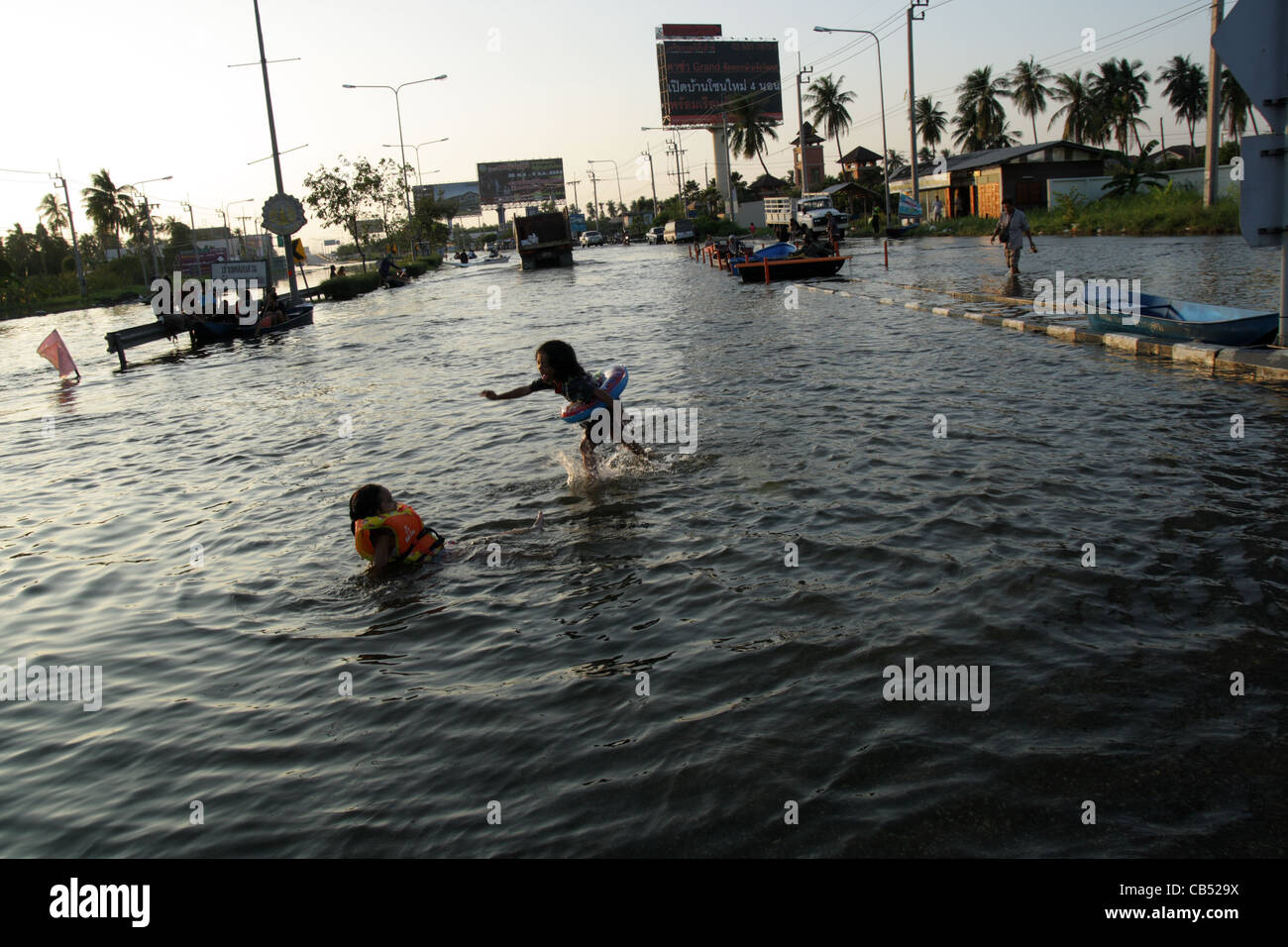 Child playing in floodwaters at Pakkred , Nonthaburi province ...